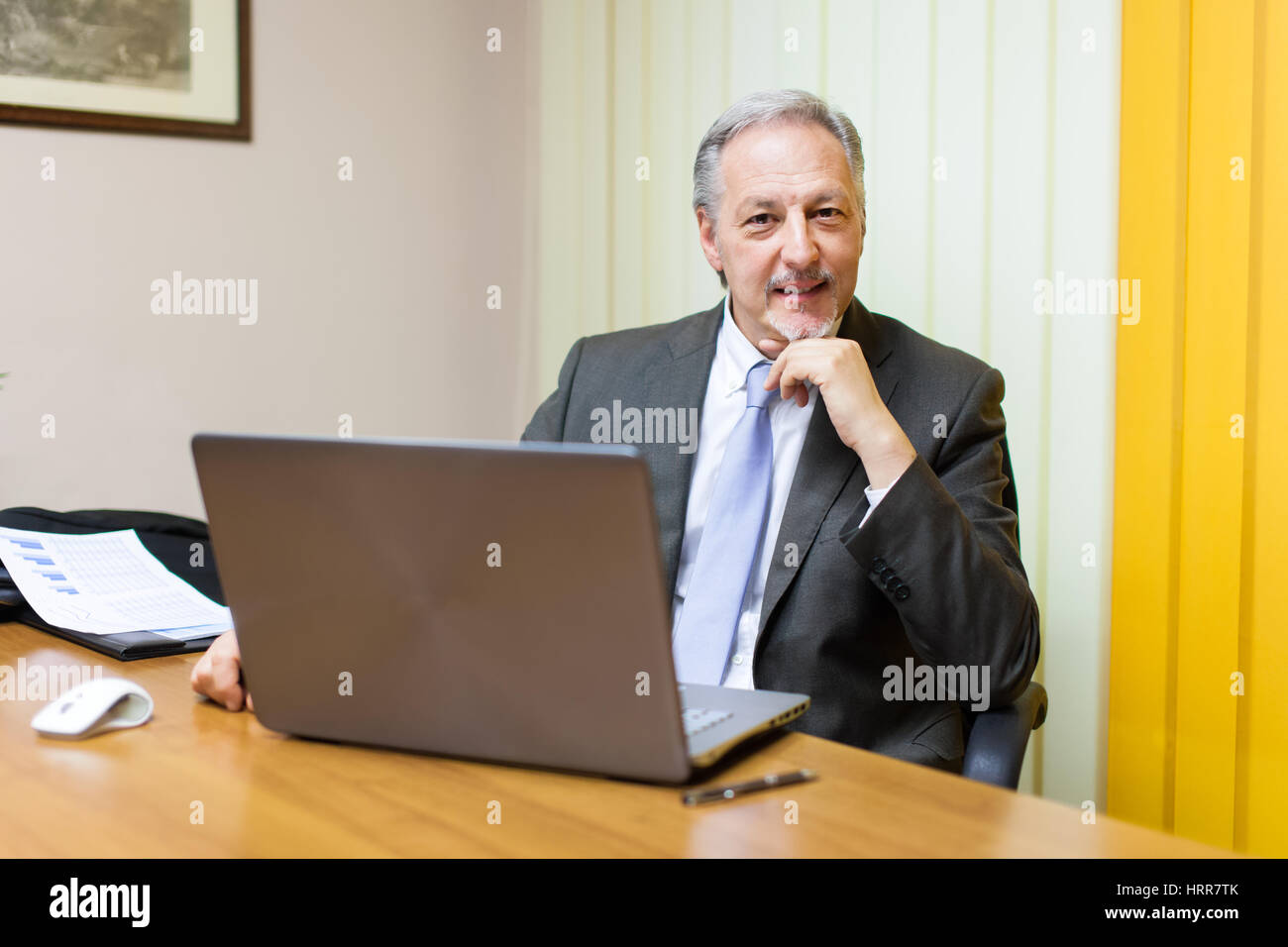 Portrait of a smiling senior businessman sitting in his office Stock ... Portrait of a smiling senior businessman sitting in his office Stock ...