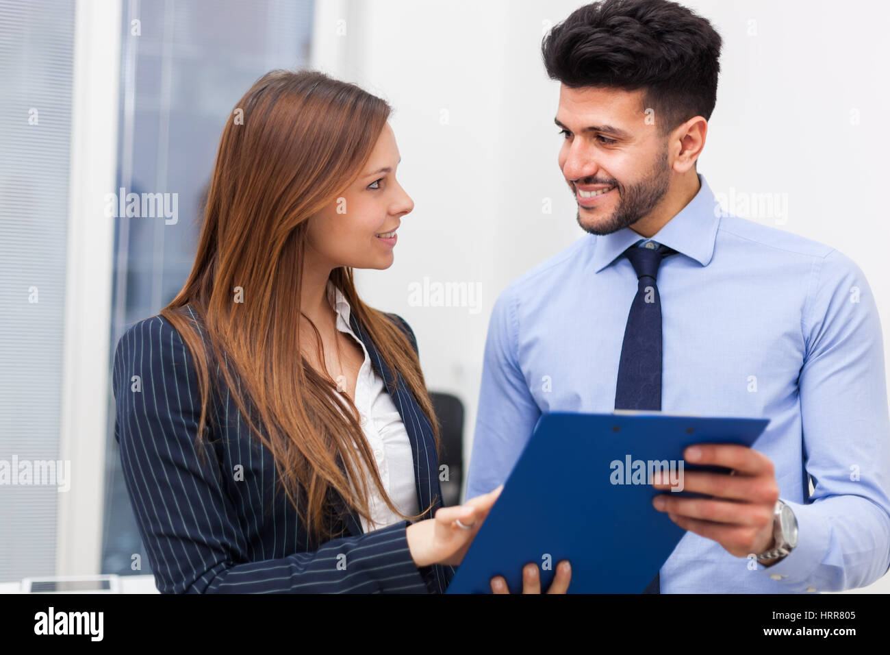 Business partners reading a document Stock Photo - Alamy