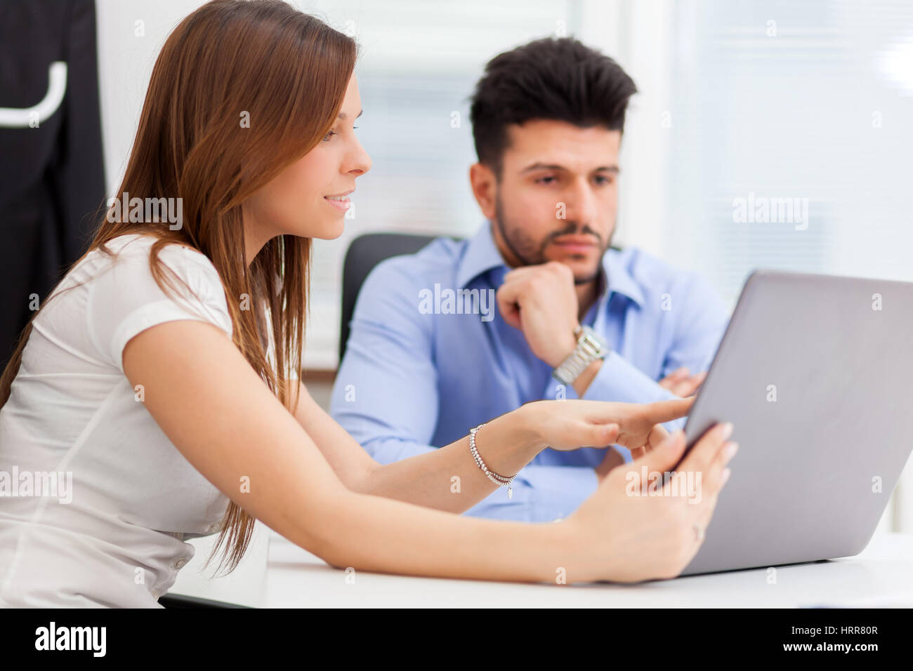Smiling business people using a computer in their office Stock Photo ...