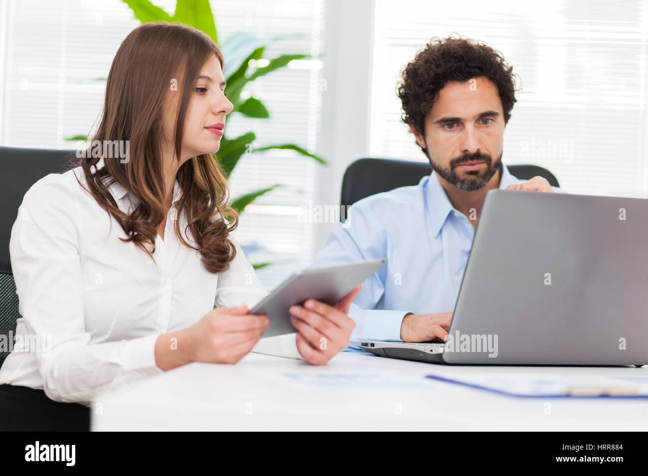 Couple working in their office Stock Photo - Alamy