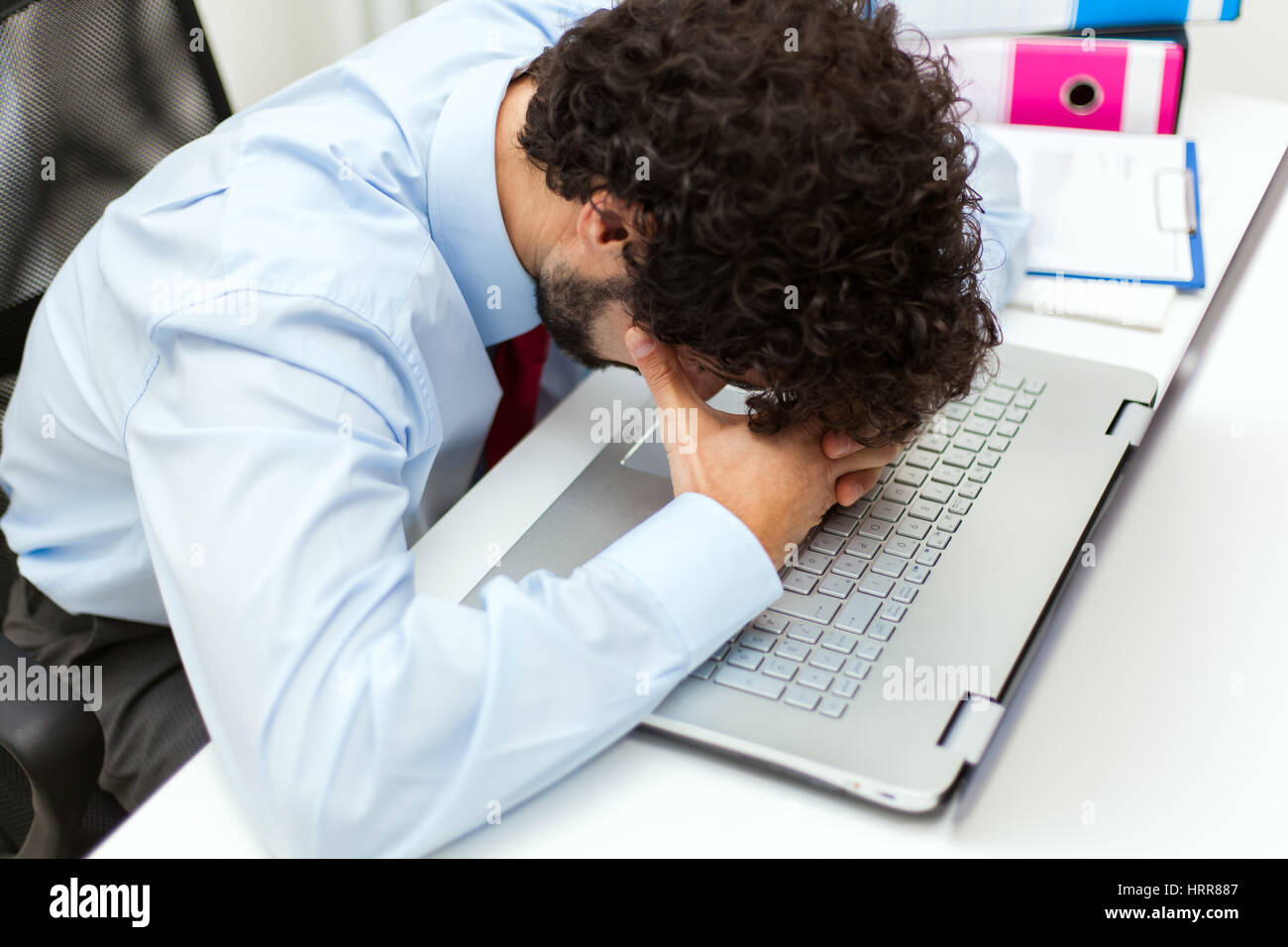 Stressed businessman looking at his computer Stock Photo - Alamy