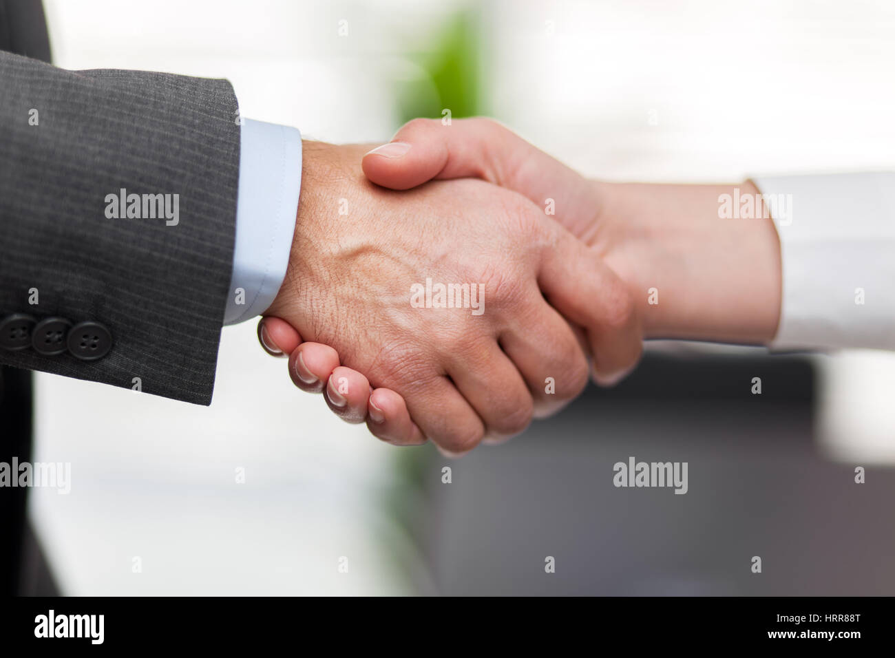 Businessmen shaking hands to seal a deal Stock Photo - Alamy