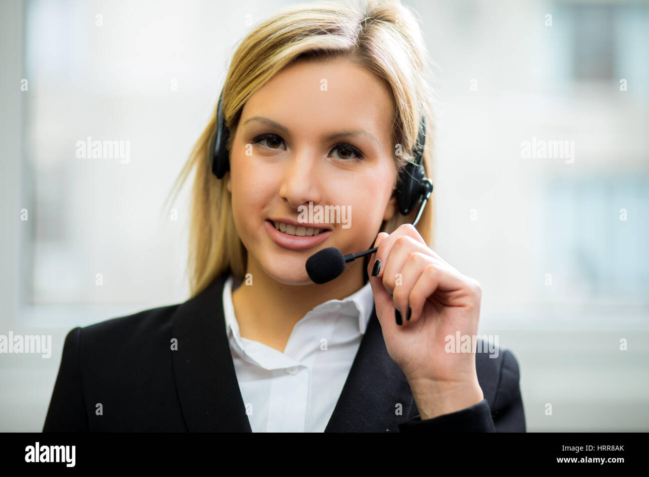 Portrait of a beautiful customer representative in an office ...