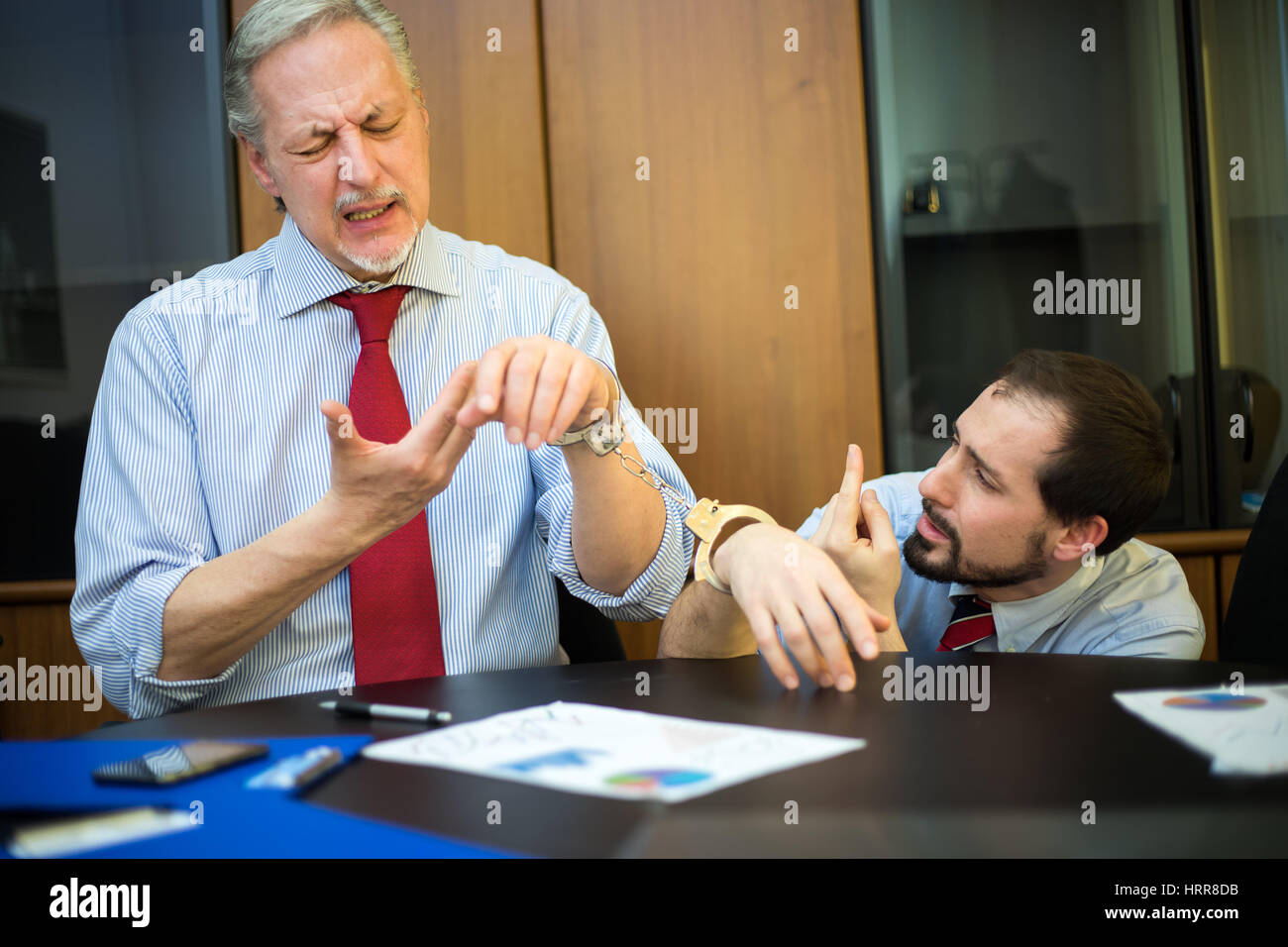 Business people in handcuffs Stock Photo - Alamy