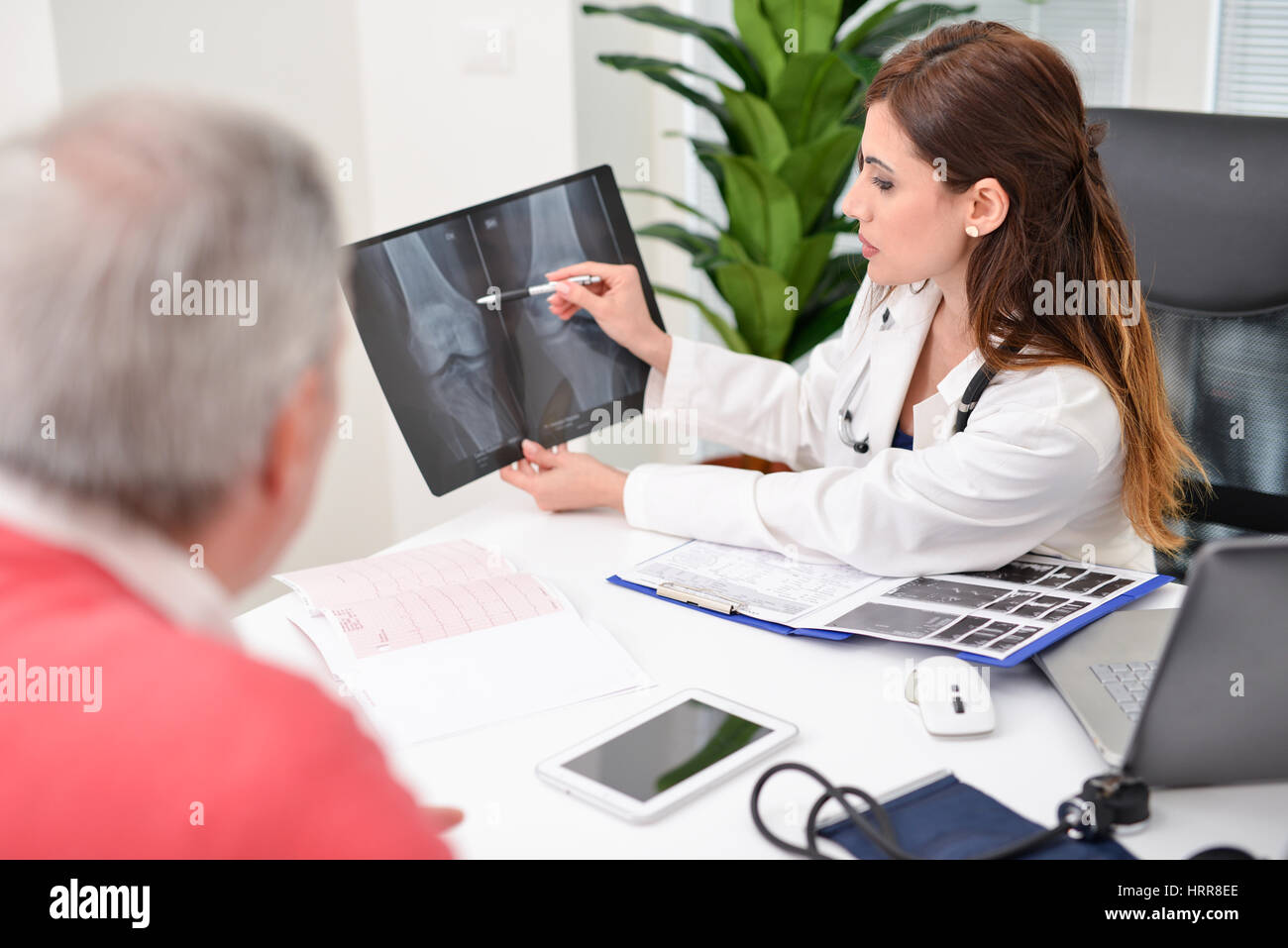 Doctor showing a radiography to a patient Stock Photo - Alamy