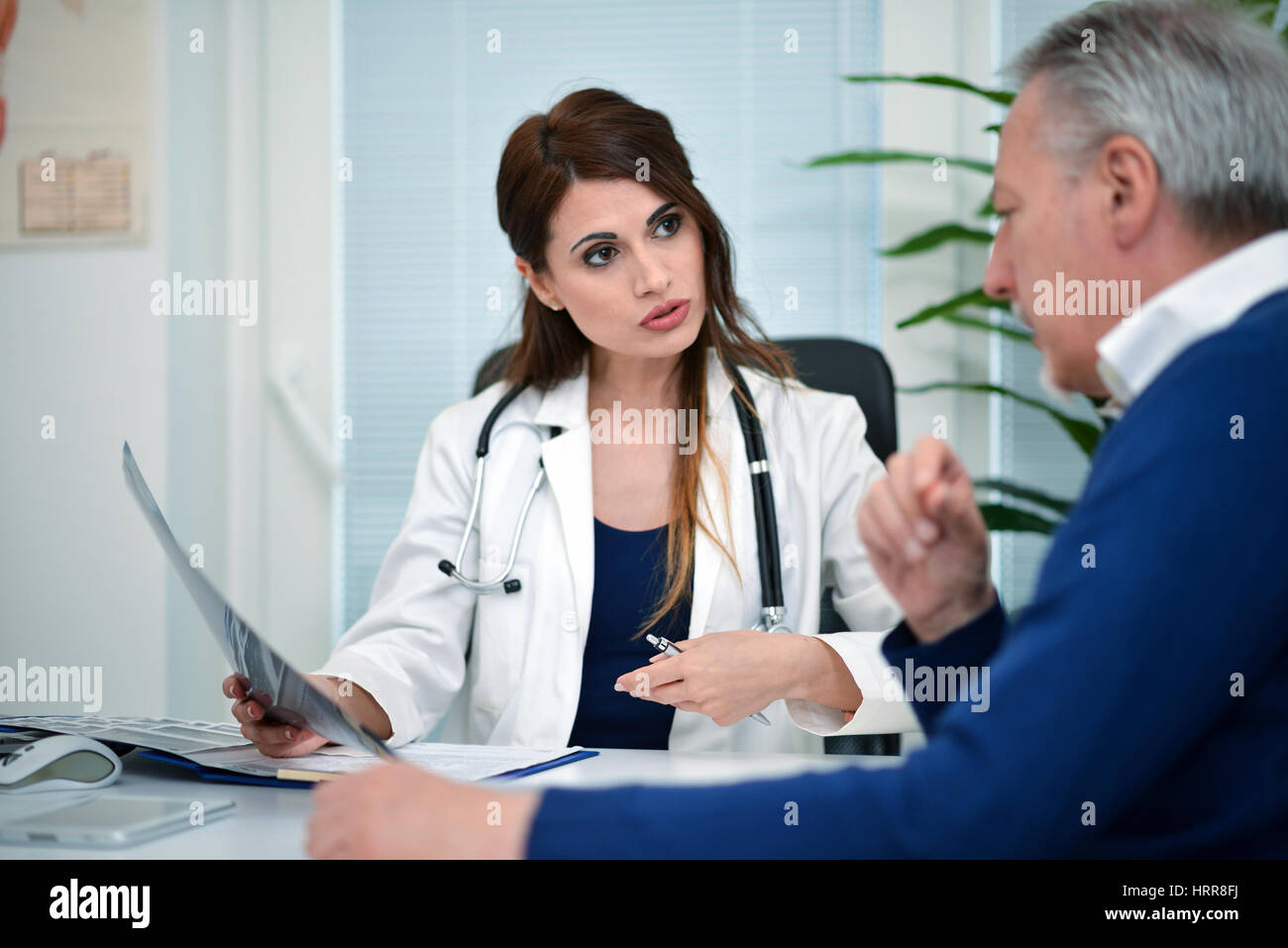 Doctor talking to a patient Stock Photo - Alamy