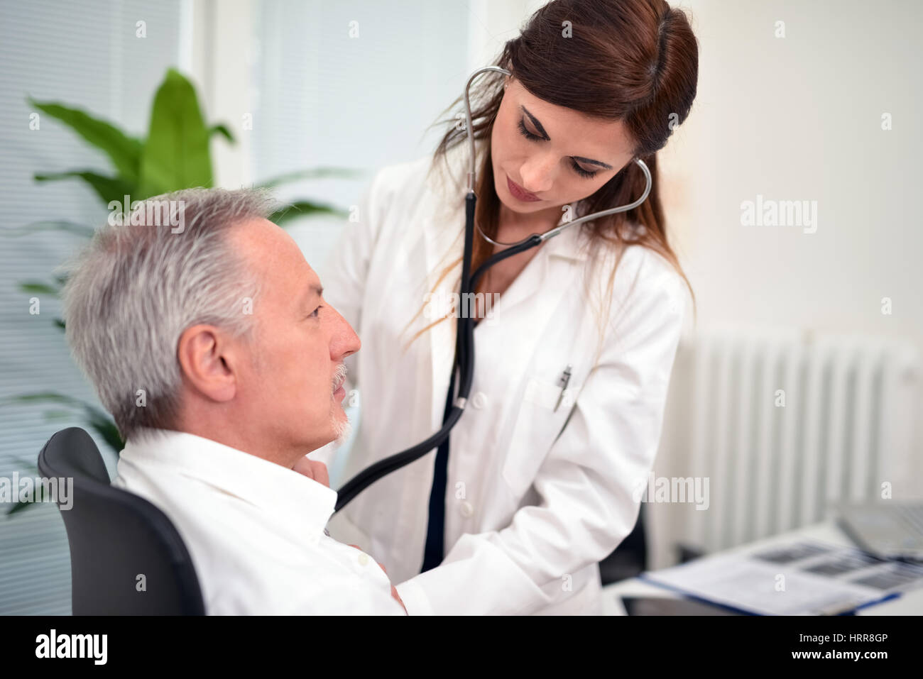Doctor visiting a patient Stock Photo - Alamy