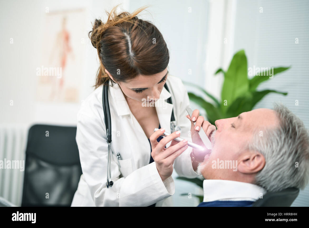 Doctor checking patients throat hi-res stock photography and images - Alamy