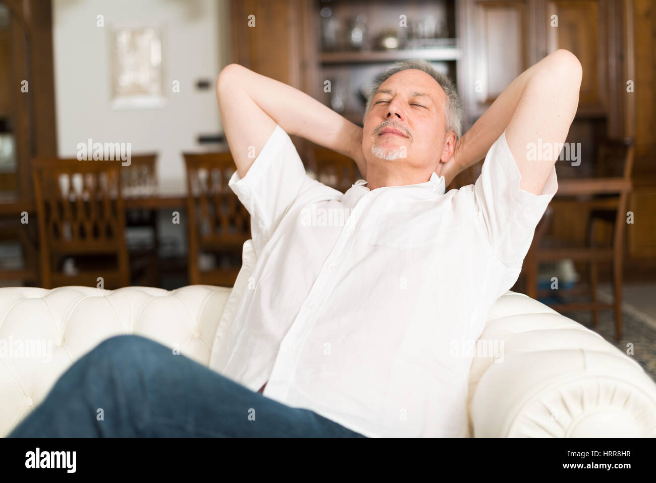 Portrait of a man relaxing in his apartment Stock Photo - Alamy