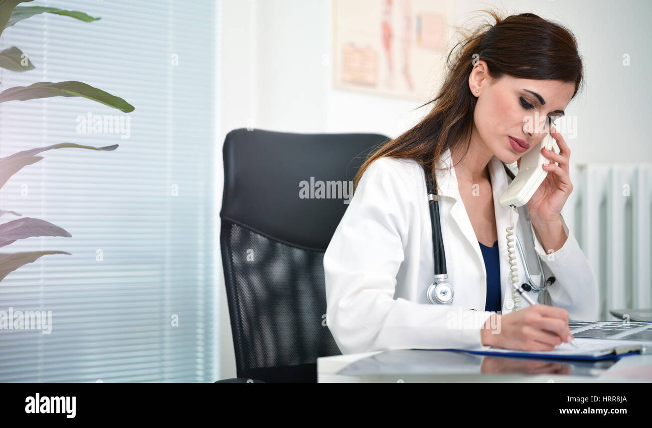 Doctor talking on the phone in her office Stock Photo - Alamy