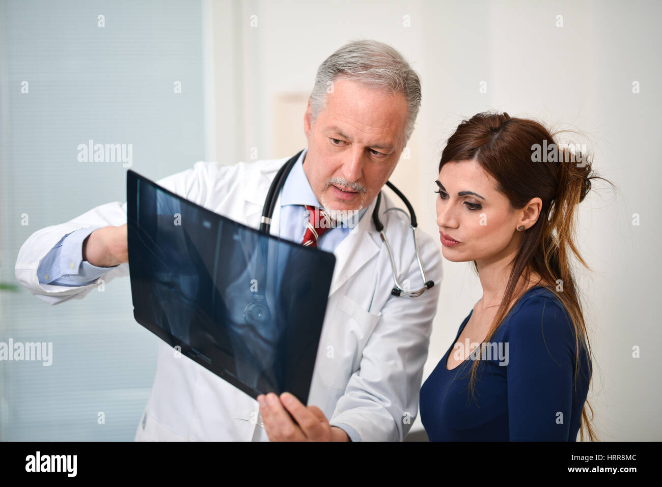 Doctor showing a radiography to his patient Stock Photo - Alamy