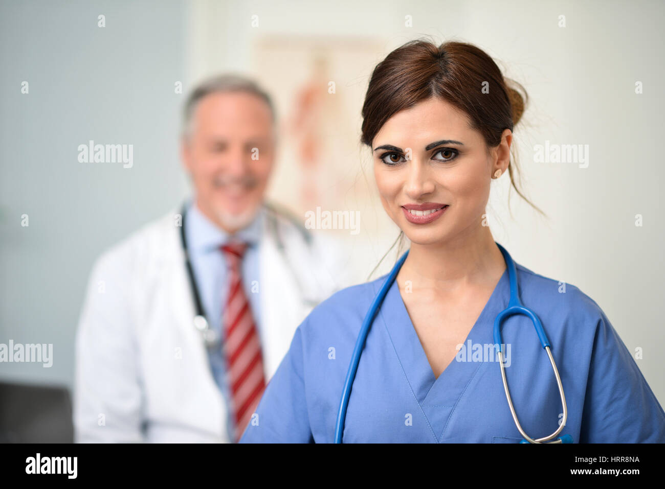 Portrait of smiling doctors in their office Stock Photo - Alamy