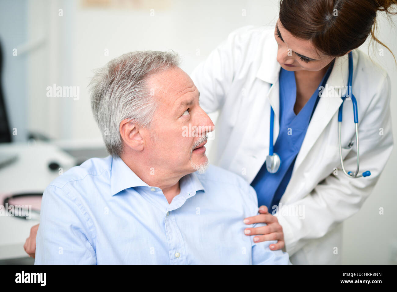 Portrait of a disabled patient talking to a doctor Stock Photo - Alamy