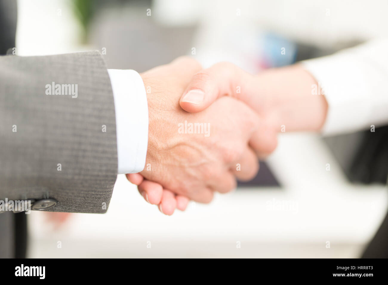 Business people shaking hands in an office Stock Photo - Alamy