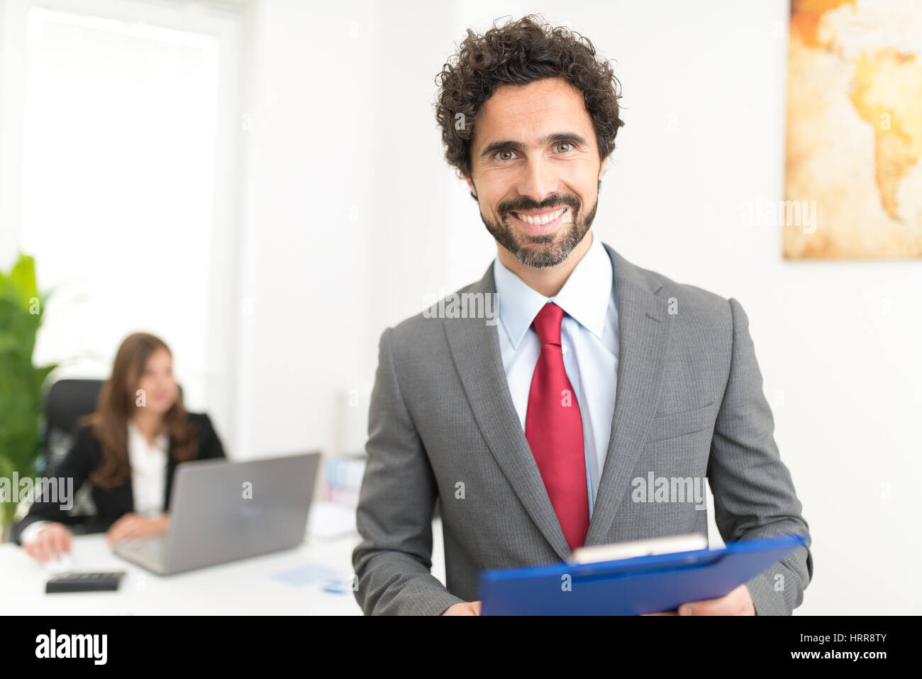 Portrait of a smiling business man in his office Stock Photo - Alamy