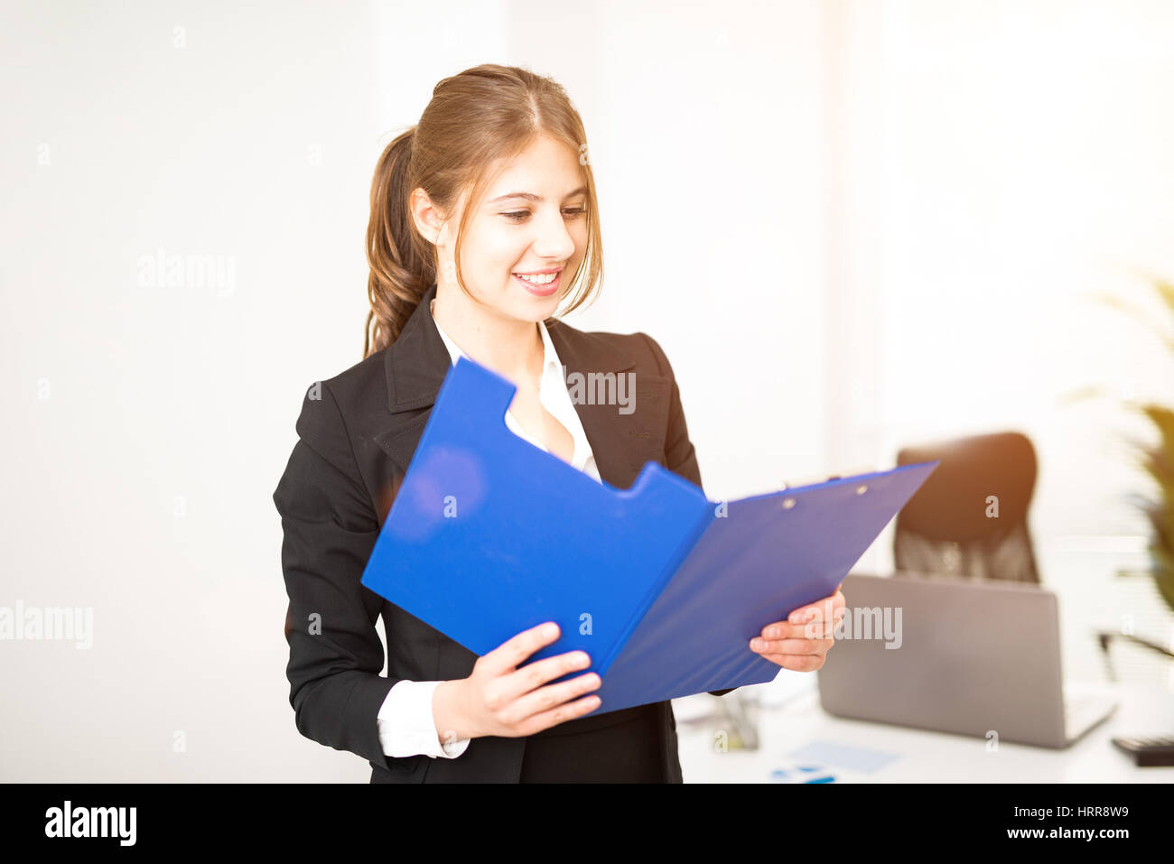 Business woman reading a document Stock Photo - Alamy