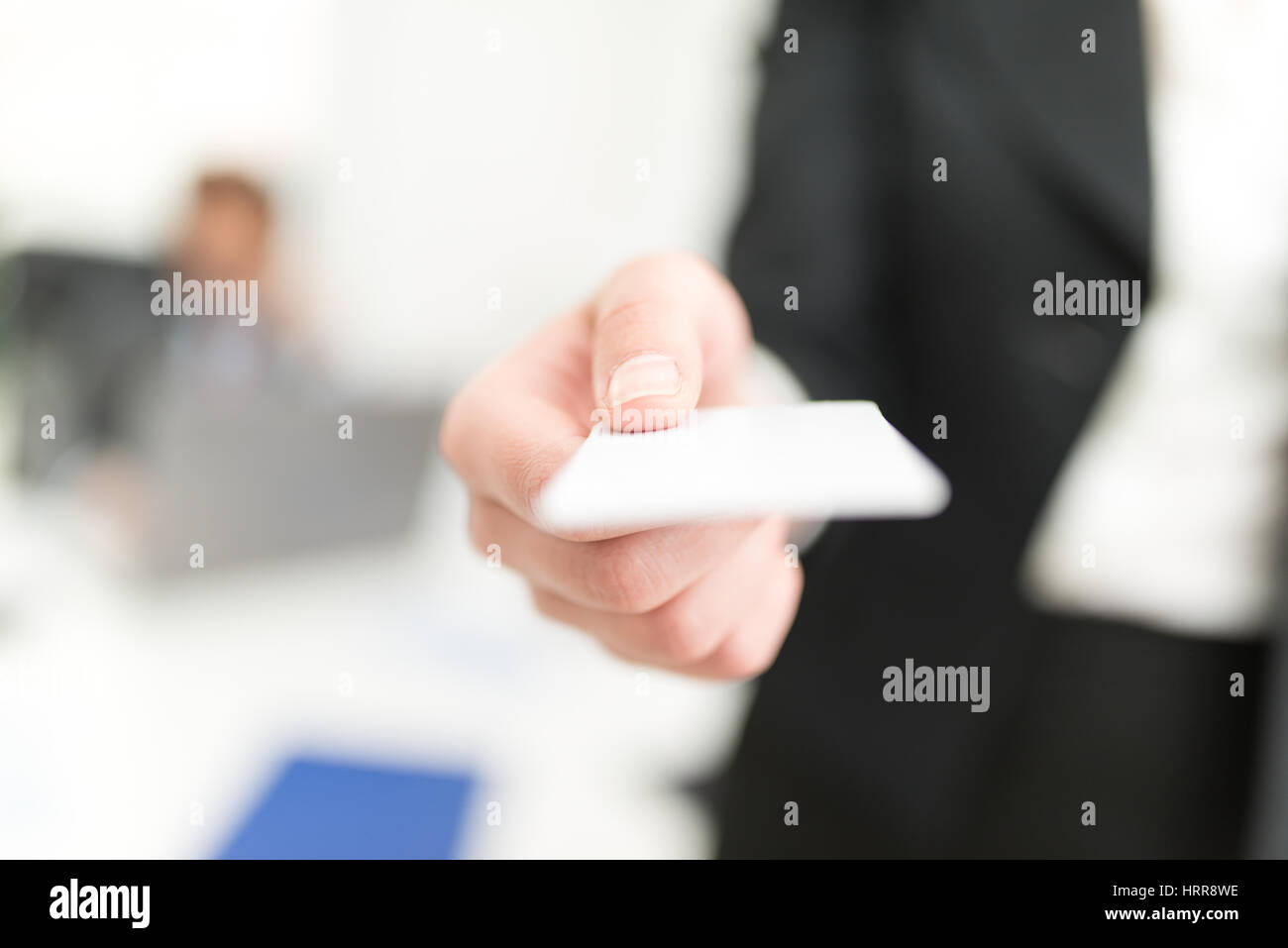 Woman giving a business card Stock Photo - Alamy