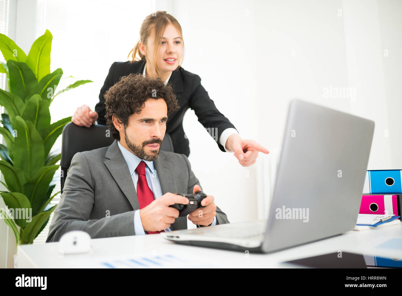 Employee playing videogames at work Stock Photo - Alamy