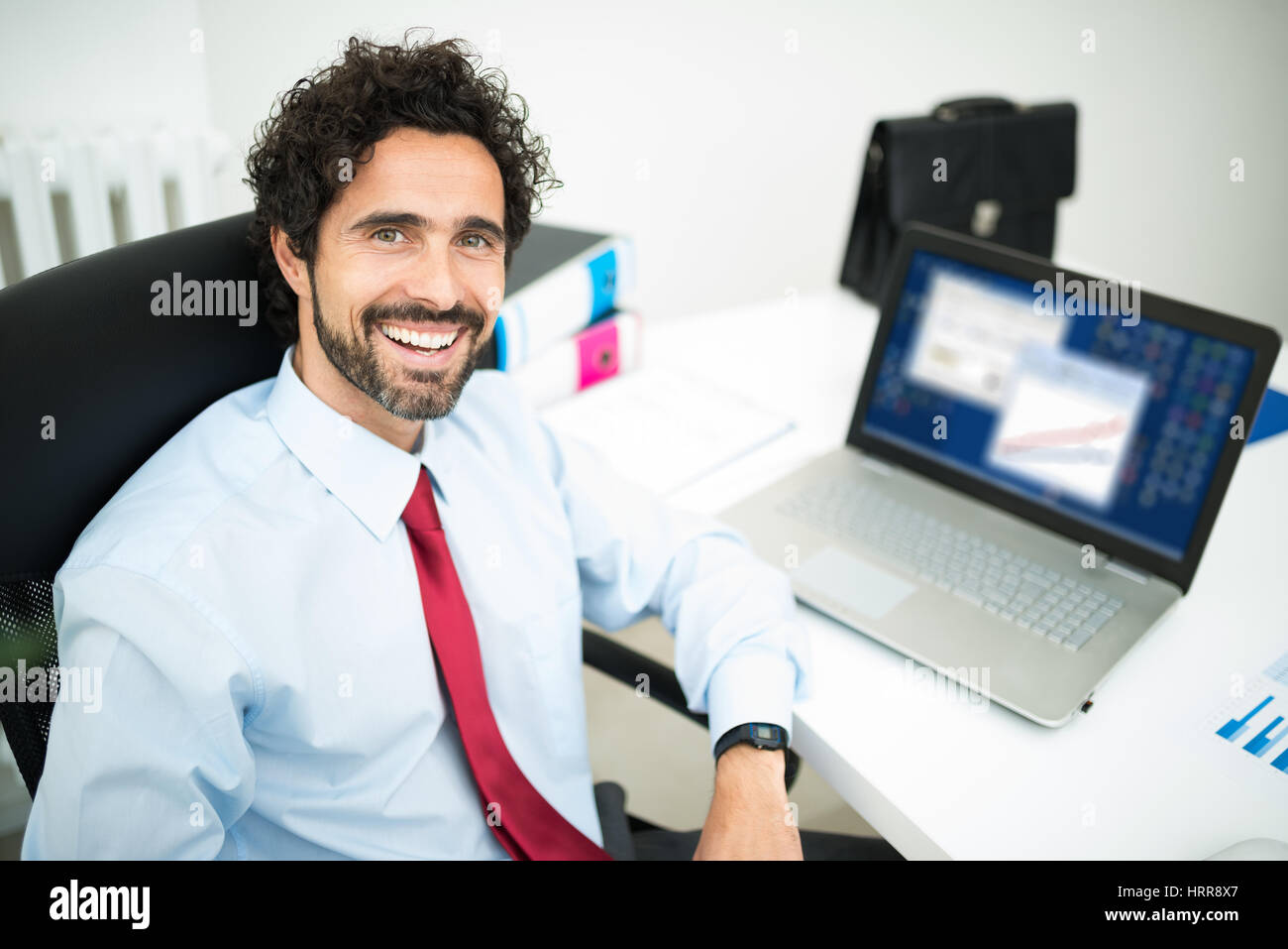 Portrait of a smiling businessman in his office Stock Photo - Alamy