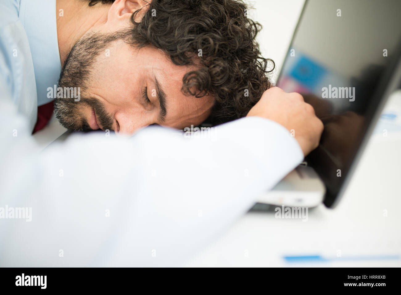 Tired businessman sleeping on his computer Stock Photo - Alamy