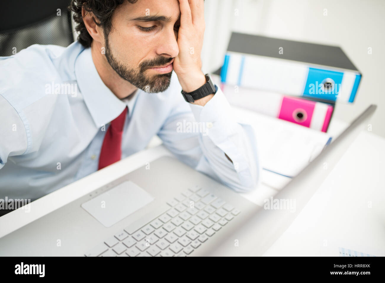Stressed businessman looking at his computer Stock Photo - Alamy
