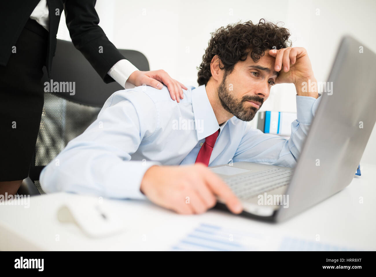 Stressed businessman looking at his computer Stock Photo - Alamy