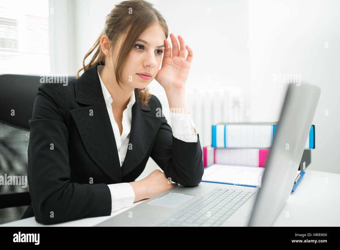 Businesswoman looking at her computer monitor Stock Photo - Alamy