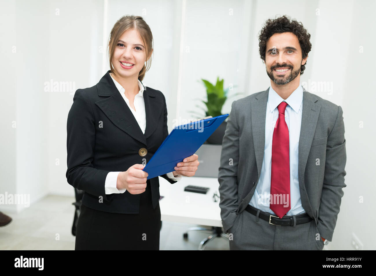 Young business people reading a document Stock Photo - Alamy