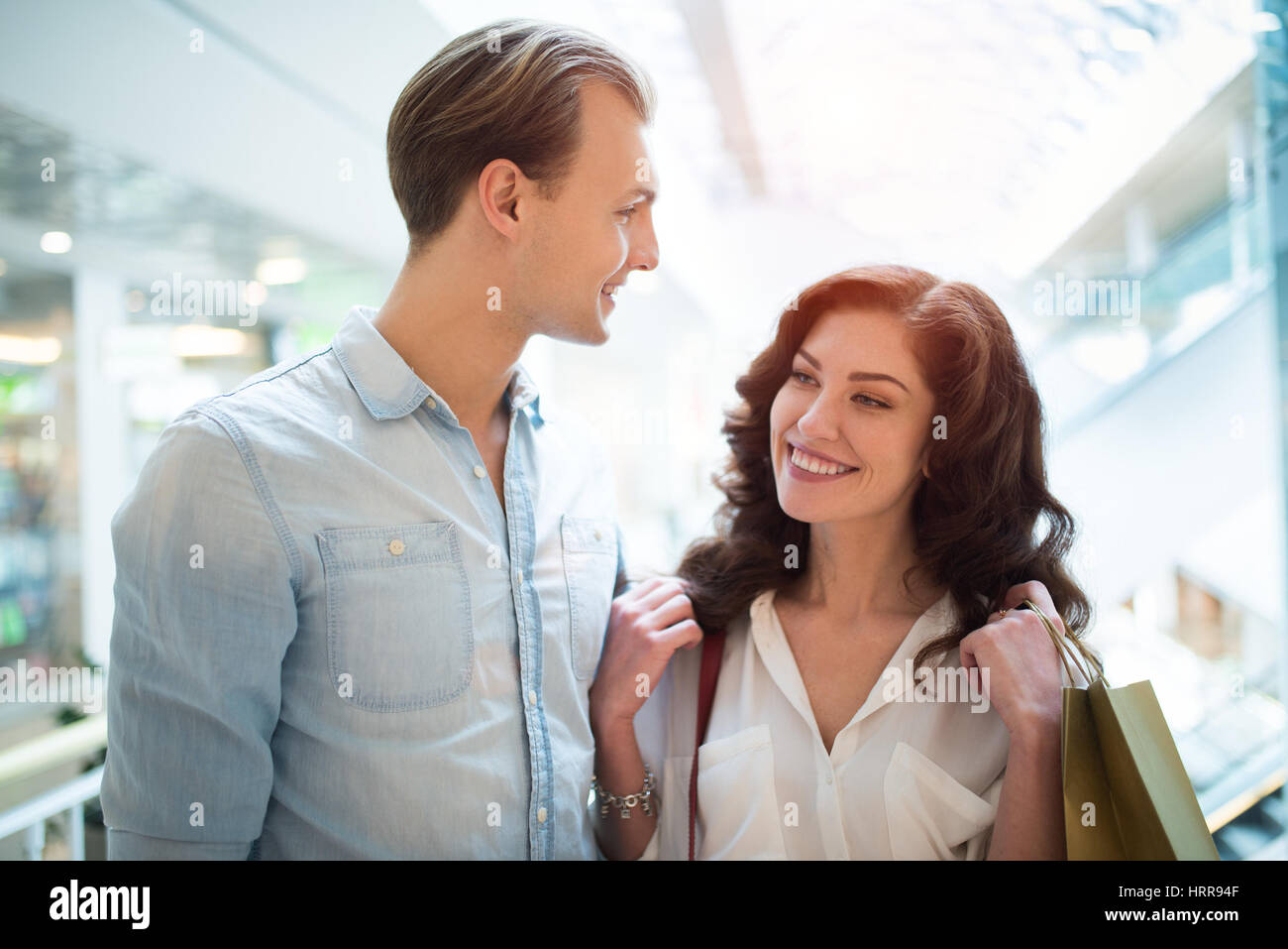 Young couple walking in a shopping mall and having fun Stock Photo - Alamy