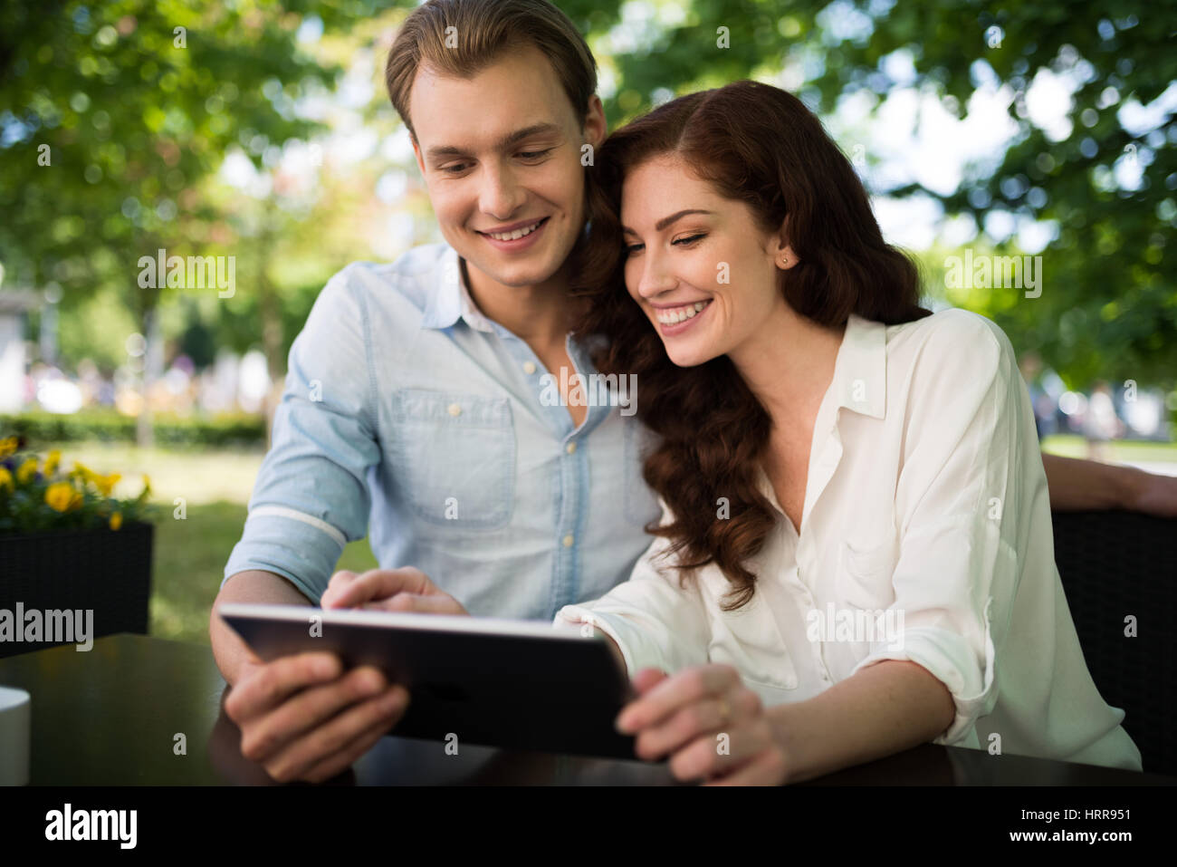 Couple using a tablet together Stock Photo - Alamy