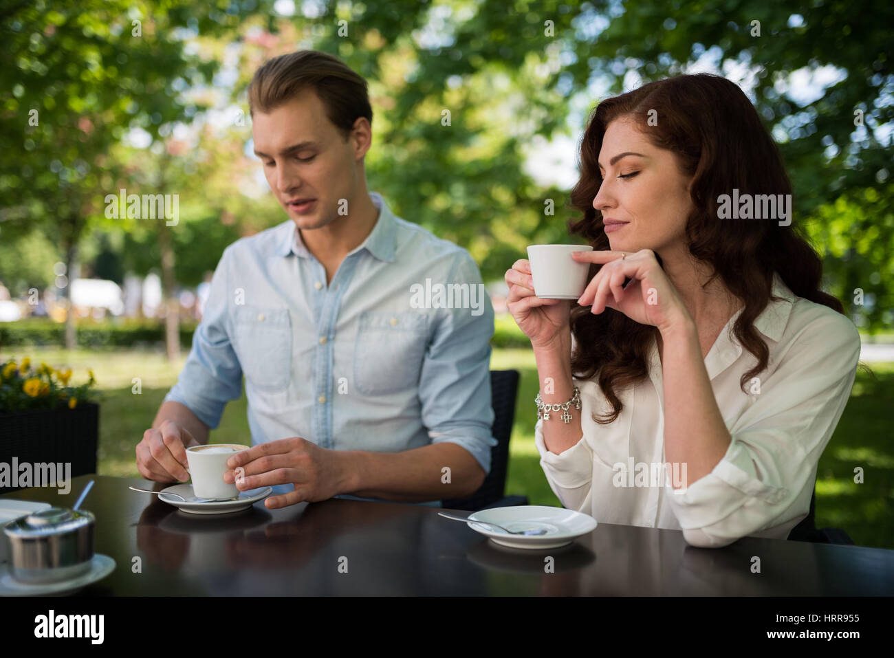 Young couple drinking a tea together outdoor Stock Photo - Alamy