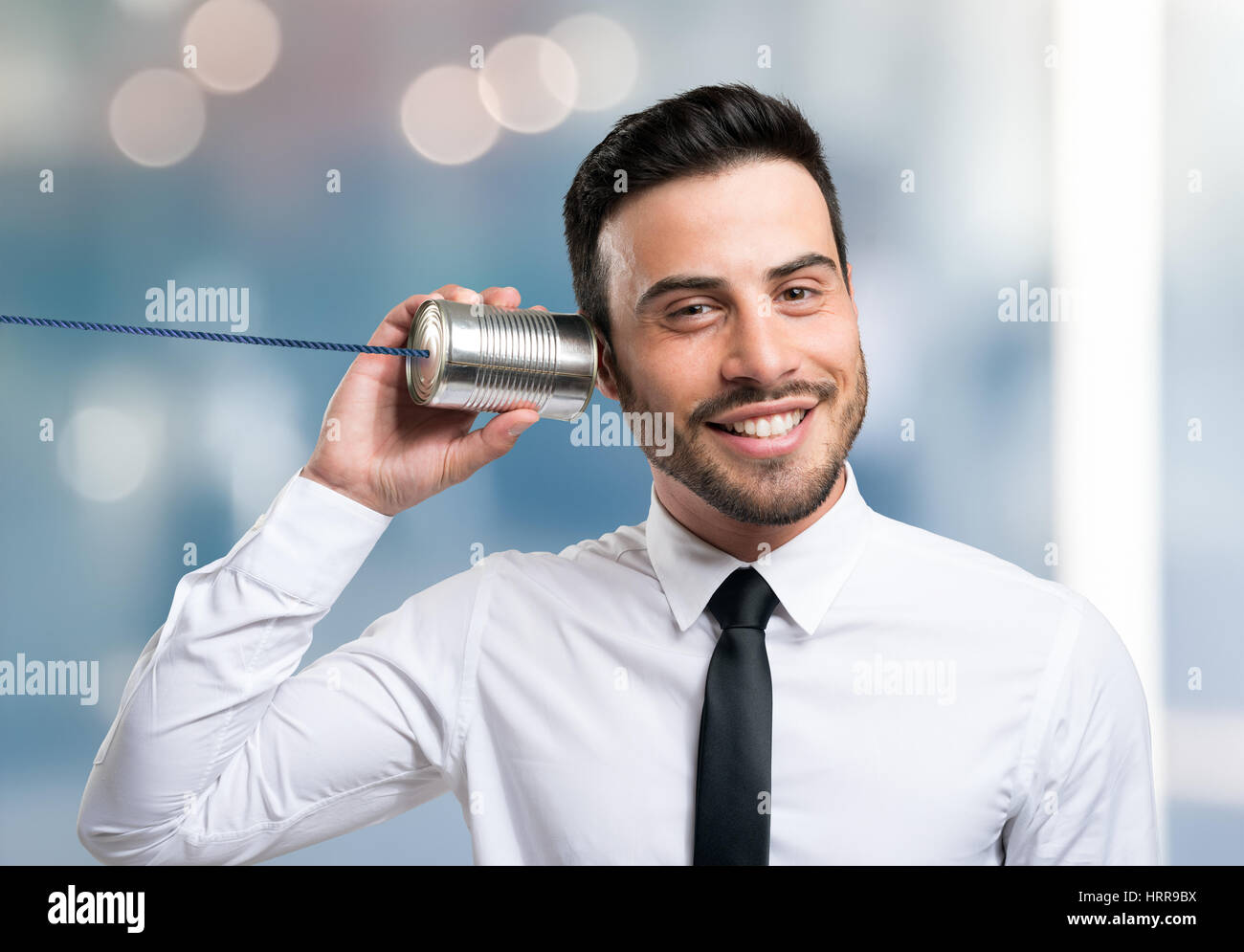 Businessman talking on a tin can phone Stock Photo - Alamy