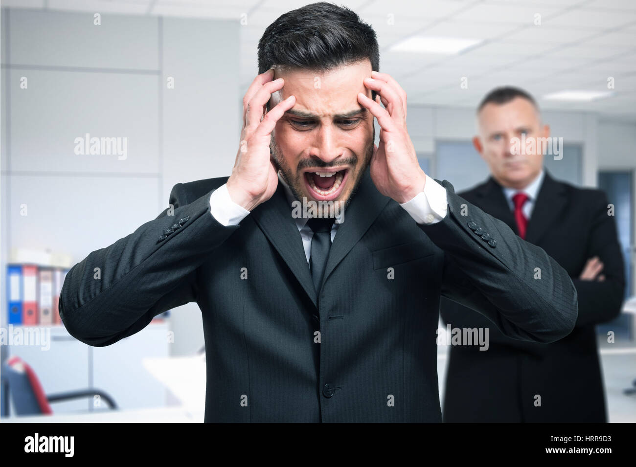 Desperate businessman in his office Stock Photo - Alamy