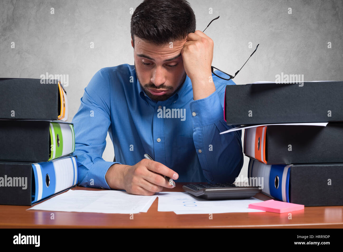 Man doing a boring job Stock Photo - Alamy