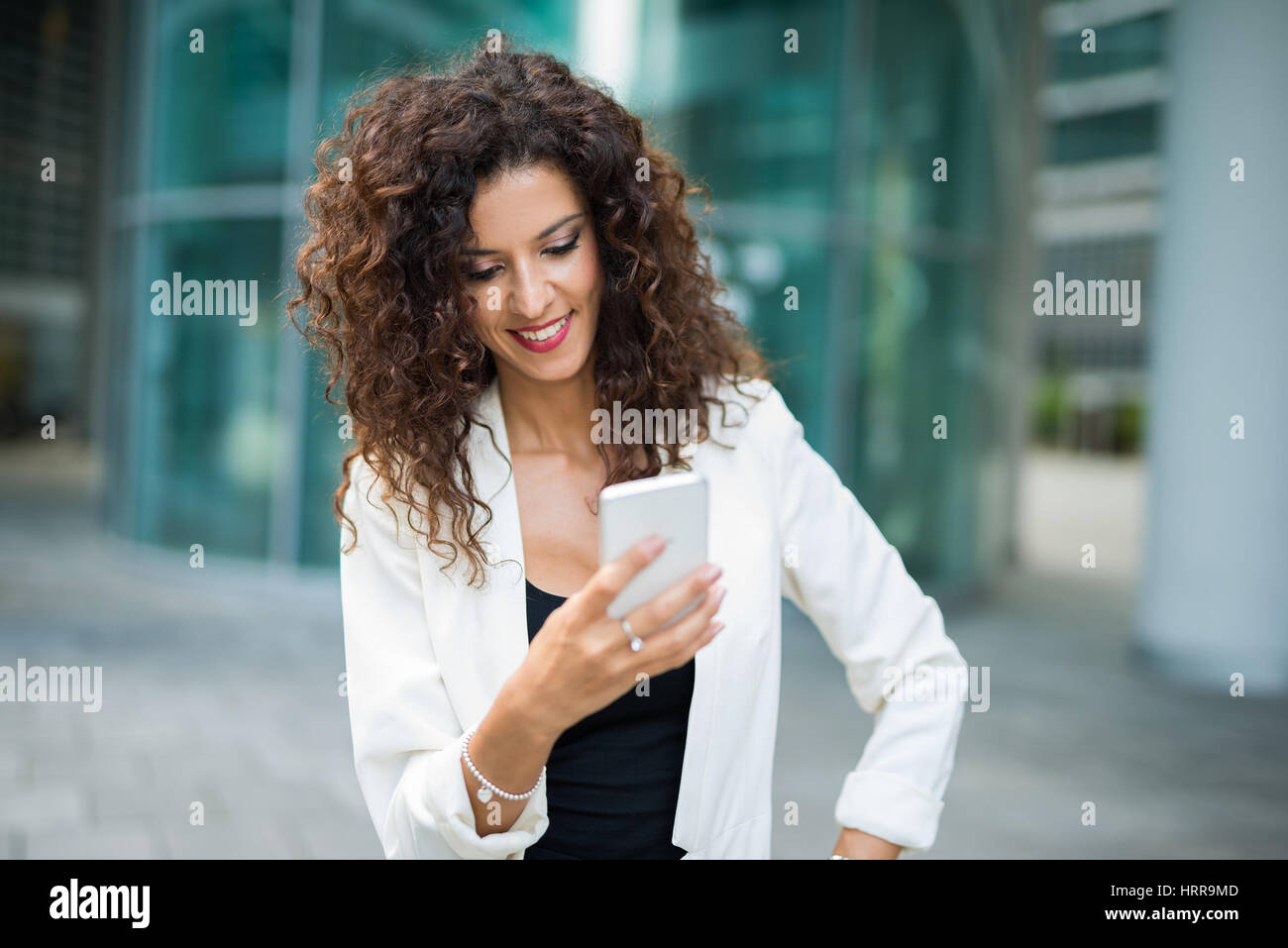 Business woman using her mobile phone Stock Photo - Alamy
