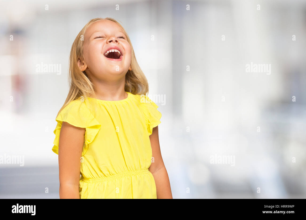 Very happy laughing child. Bright blurred background Stock Photo - Alamy