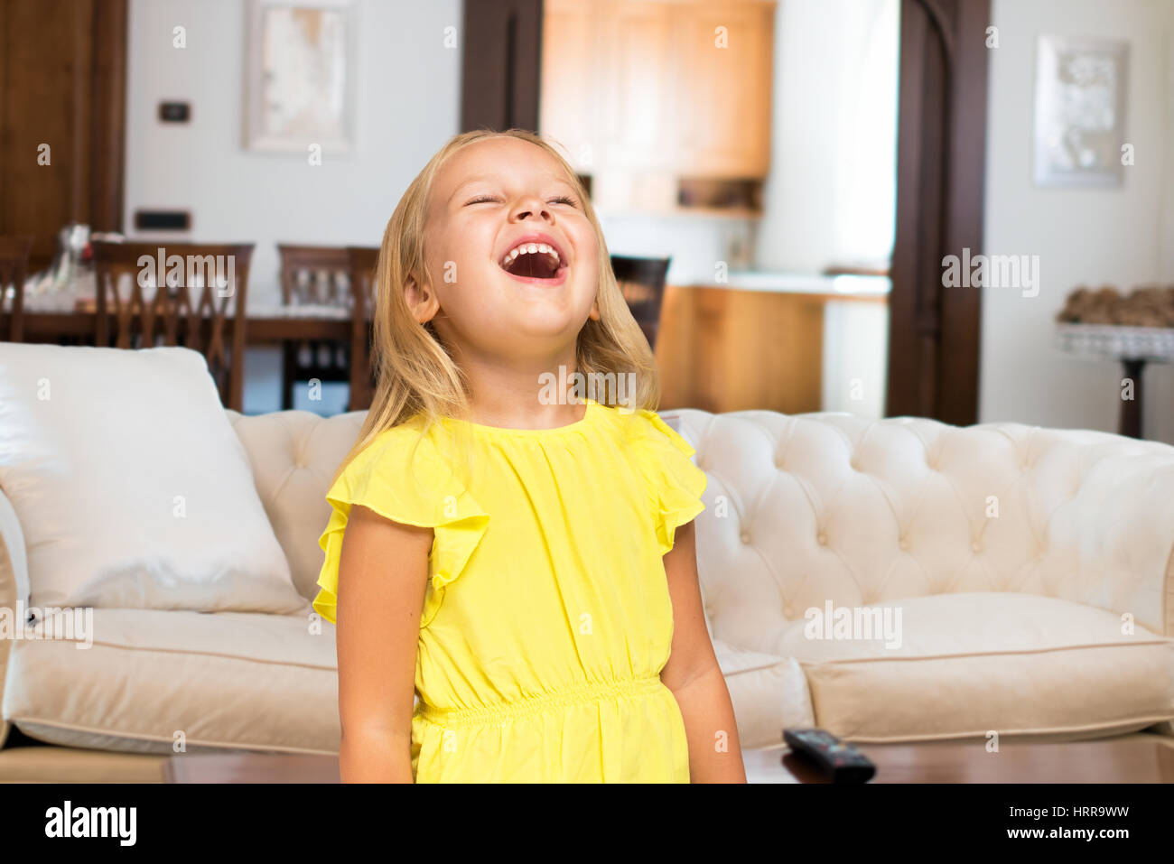 Very happy child laughing in her home Stock Photo - Alamy