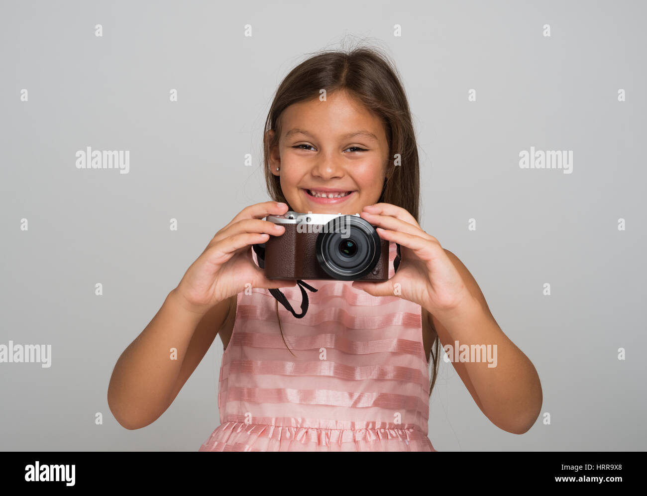 Smiling child holding a compact camera Stock Photo - Alamy