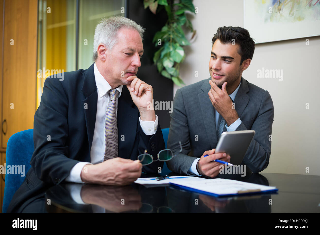 Business people using a tablet Stock Photo - Alamy