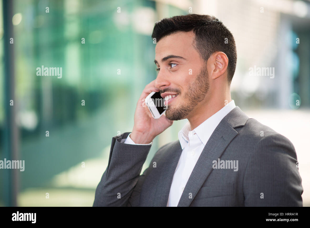 Smiling man talking on the cell phone Stock Photo - Alamy