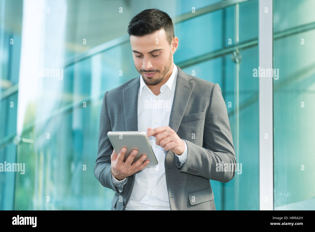Businessman using his tablet computer Stock Photo - Alamy