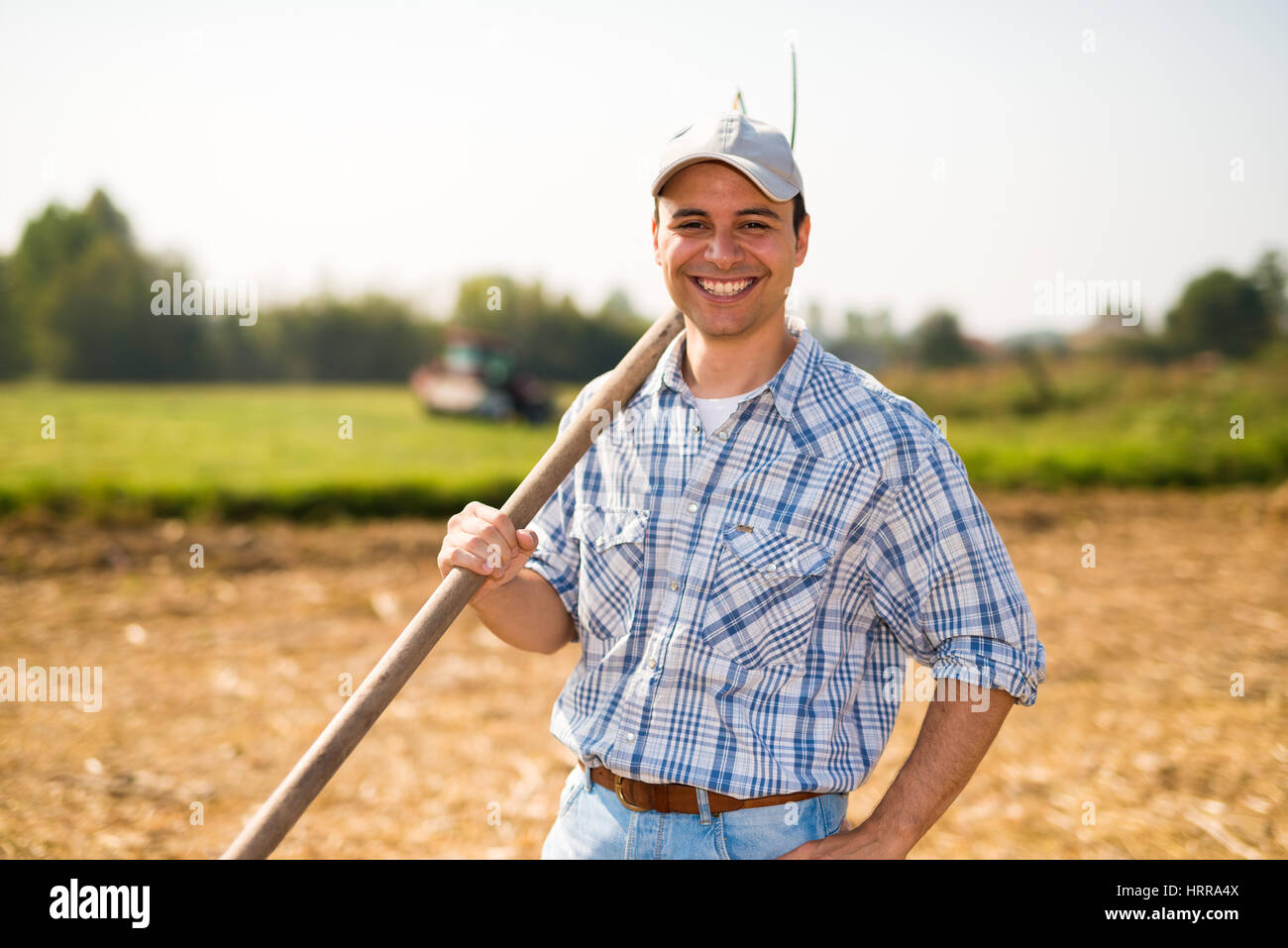 Portrait of a smiling farmer in his field Stock Photo - Alamy