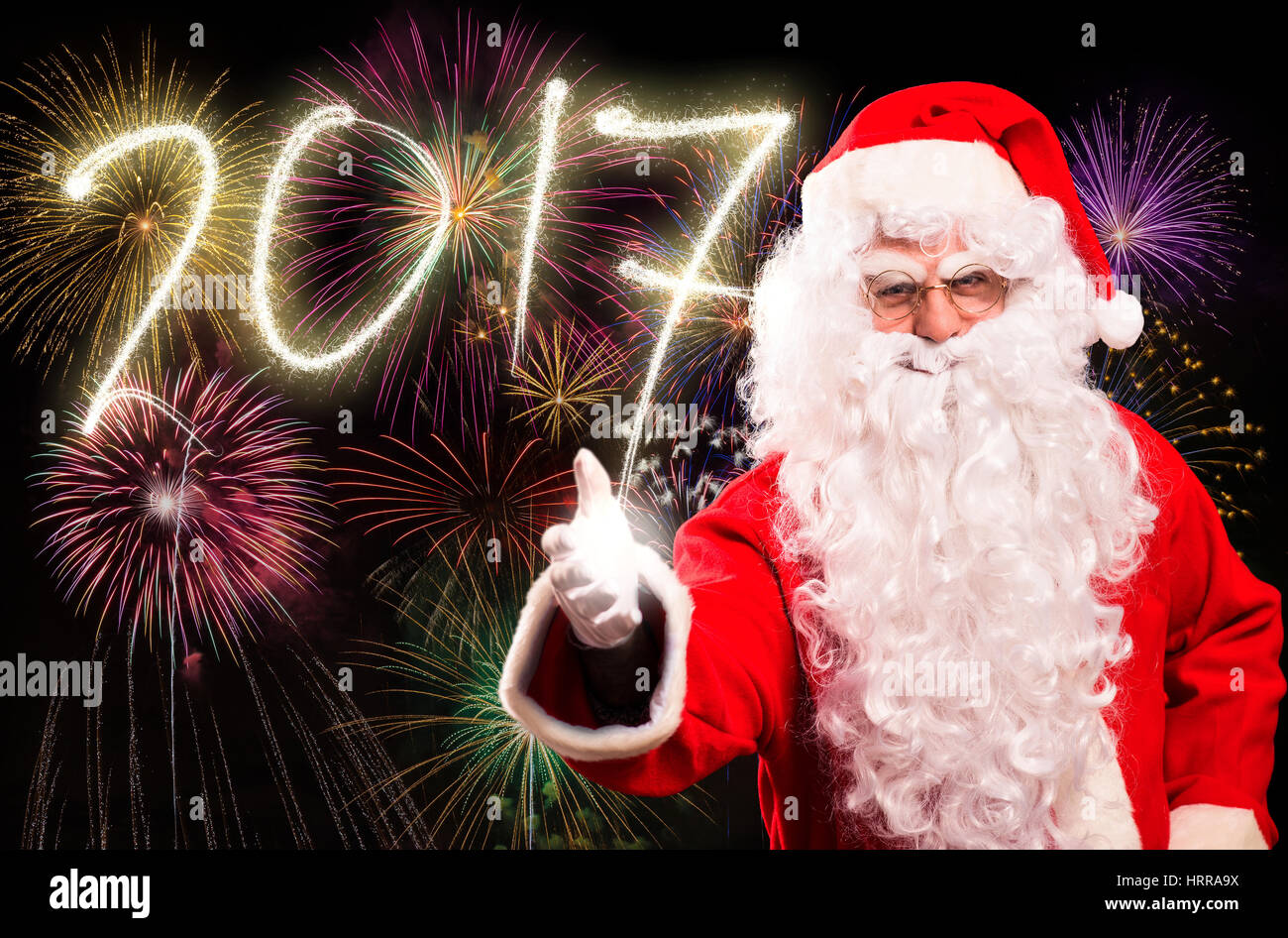 Santa Claus in front of New Year fireworks Stock Photo - Alamy