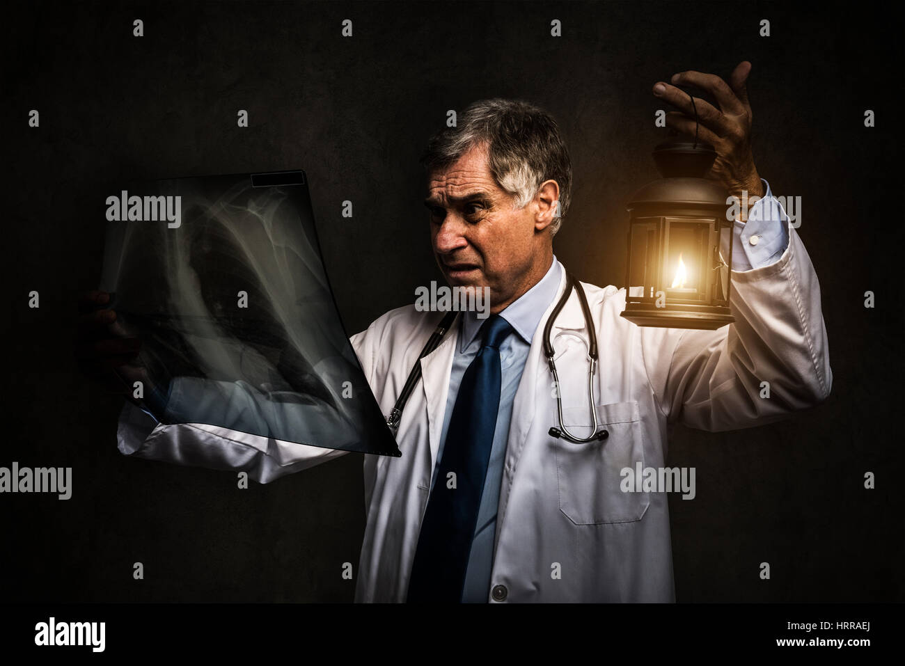 Doctor using a lantern to look at a radiography Stock Photo - Alamy