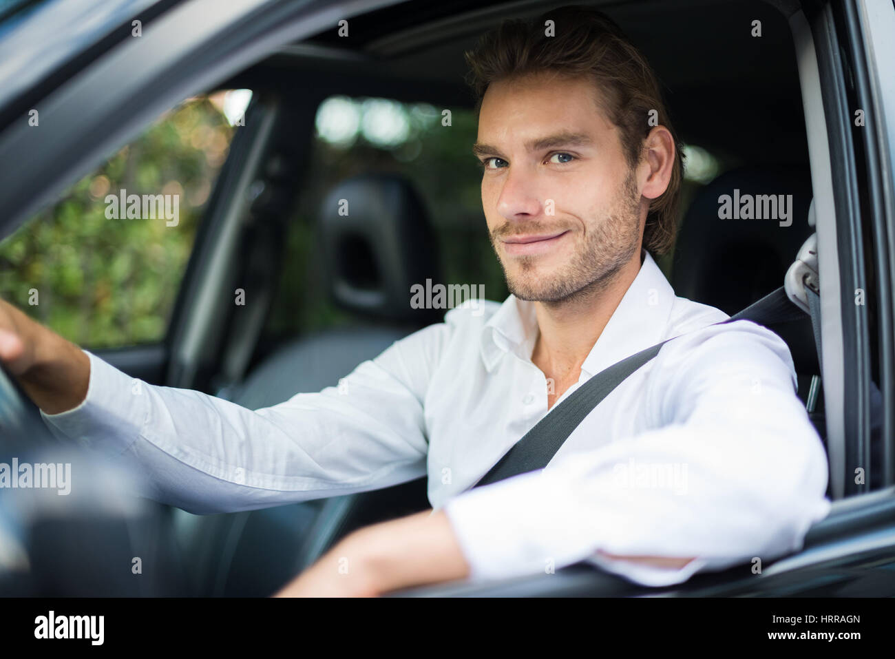 Smiling man driving his car Stock Photo - Alamy