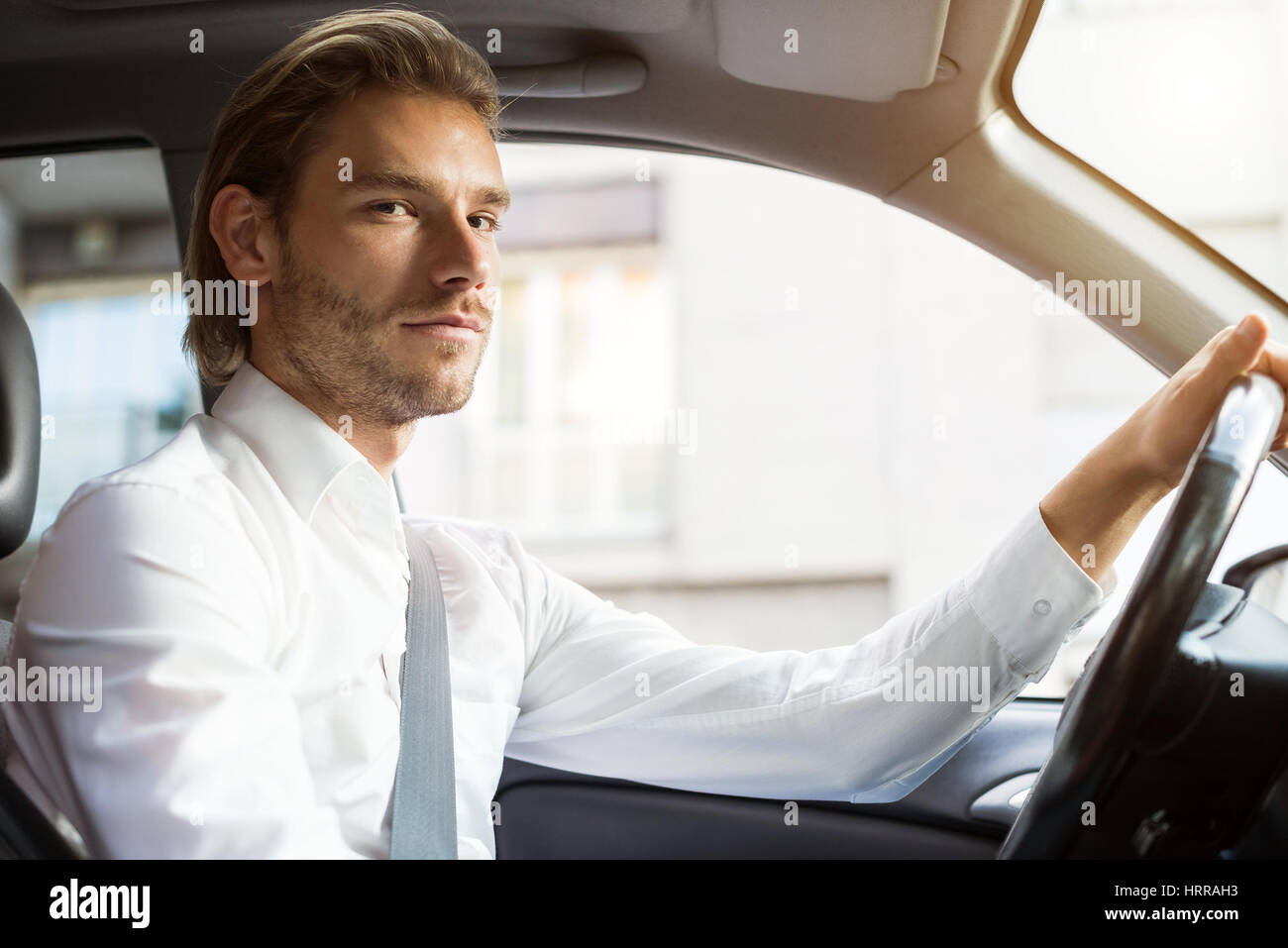 Smiling man driving his car Stock Photo - Alamy