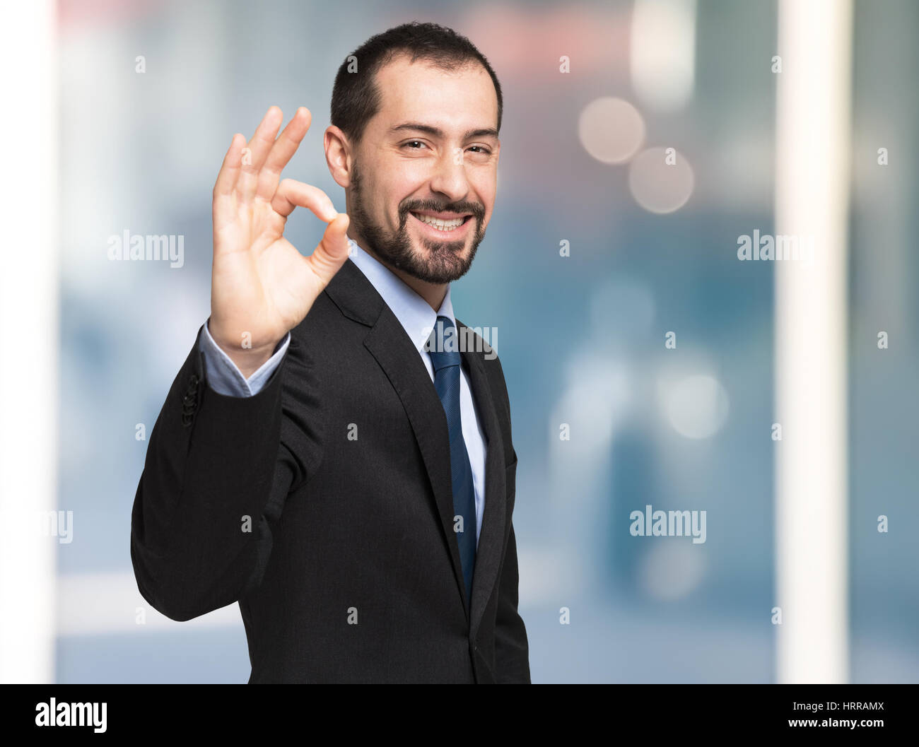 Smiling businessman making alright sign Stock Photo - Alamy