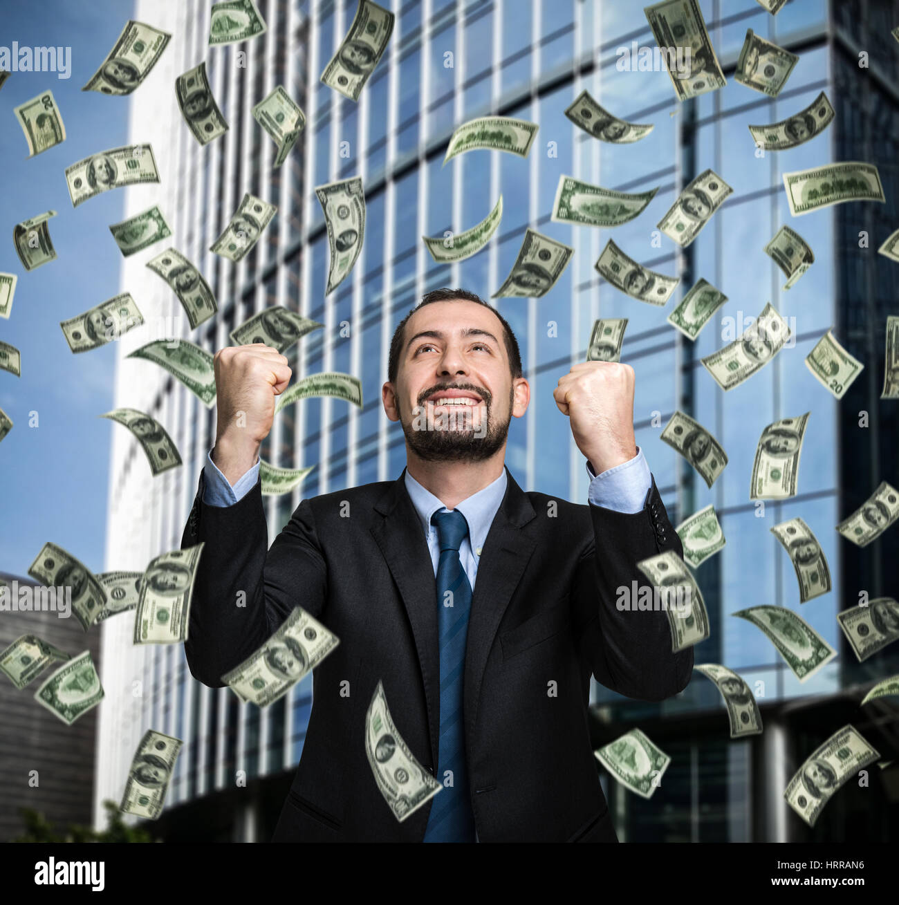 Businessman under a money rain Stock Photo - Alamy