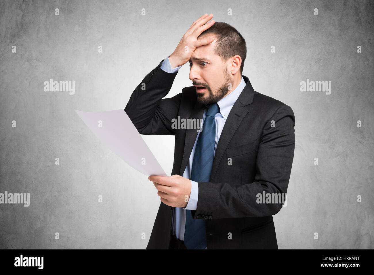 Desperate businessman reading a document Stock Photo - Alamy