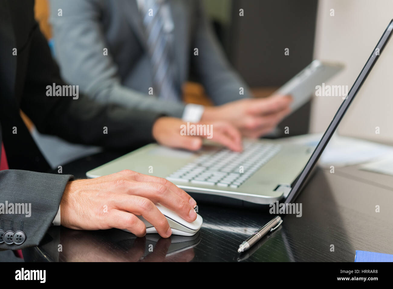 Business people at work on a laptop computer Stock Photo - Alamy